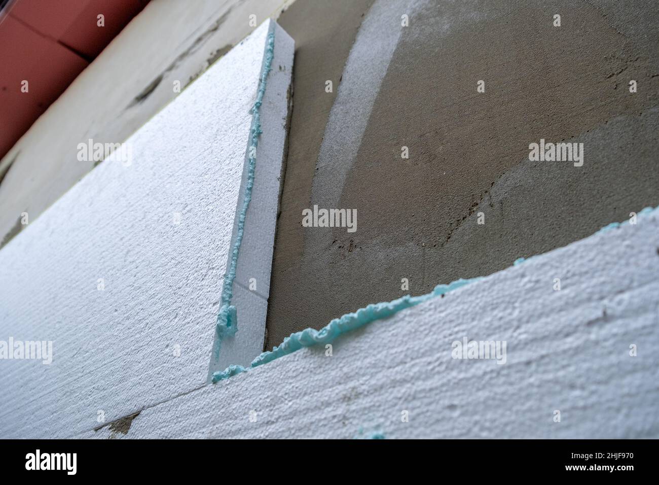 Installation of styrofoam insulation sheets on house facade wall for ...