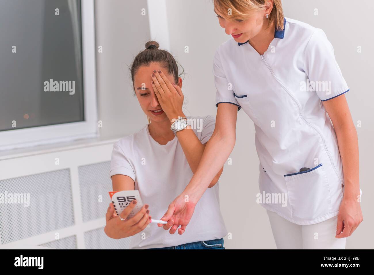 Woman ( girl )reviewing eyesight closing eye with hand. Eye test ...