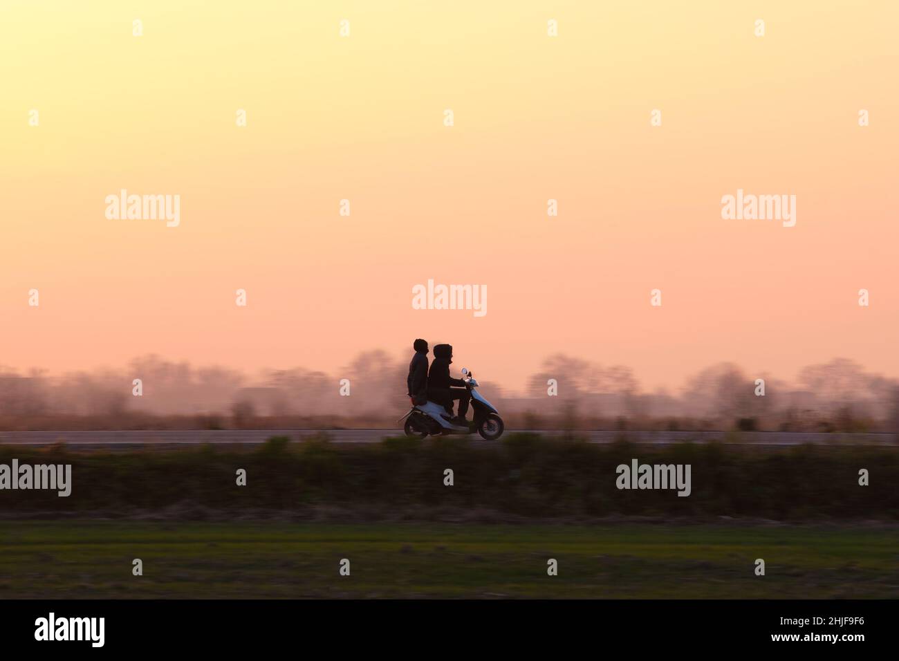 Motion blurred image of motorcycle driving fast on evening road Stock ...