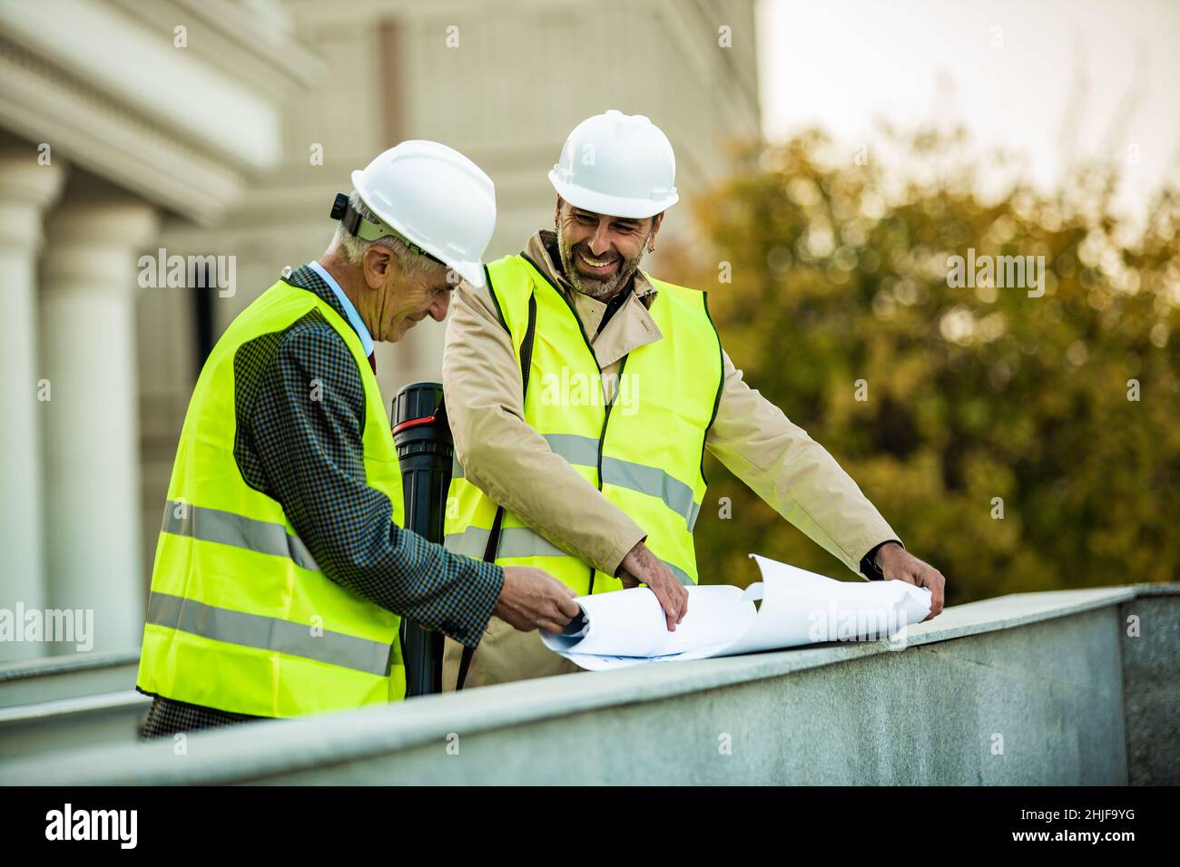 Two senior construction workers are opening the new plans Stock Photo ...