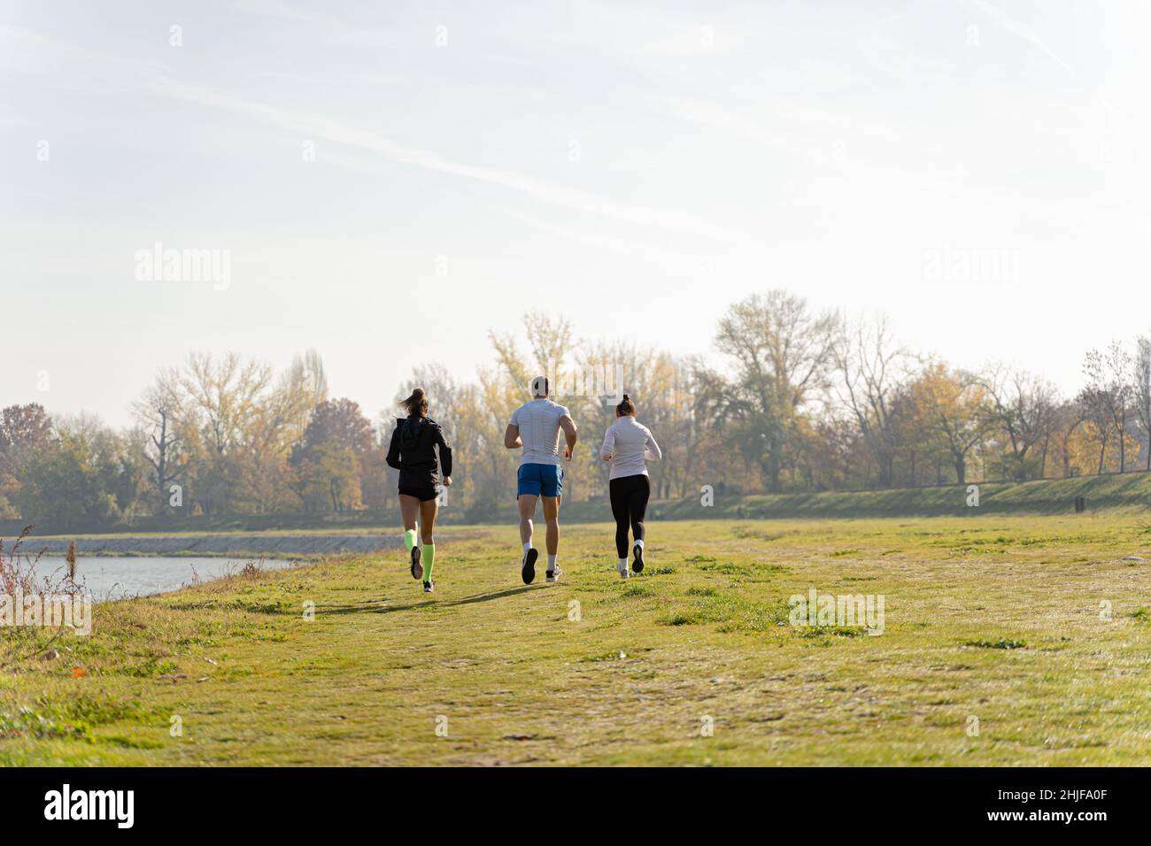Three amazing and fit friends are running together Stock Photo - Alamy