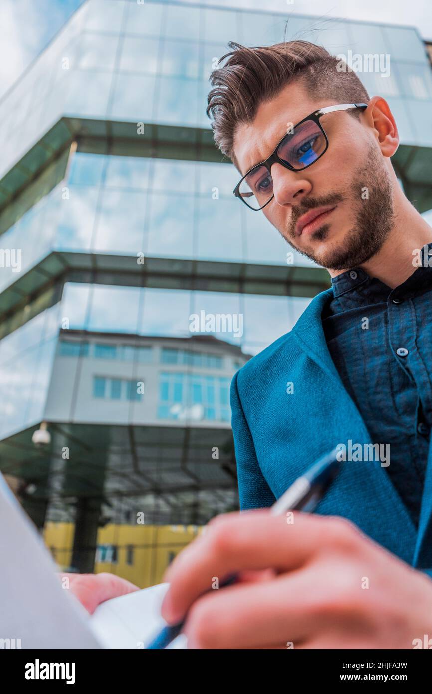 Picture of a business manager hand signing the contract outdoors near ...