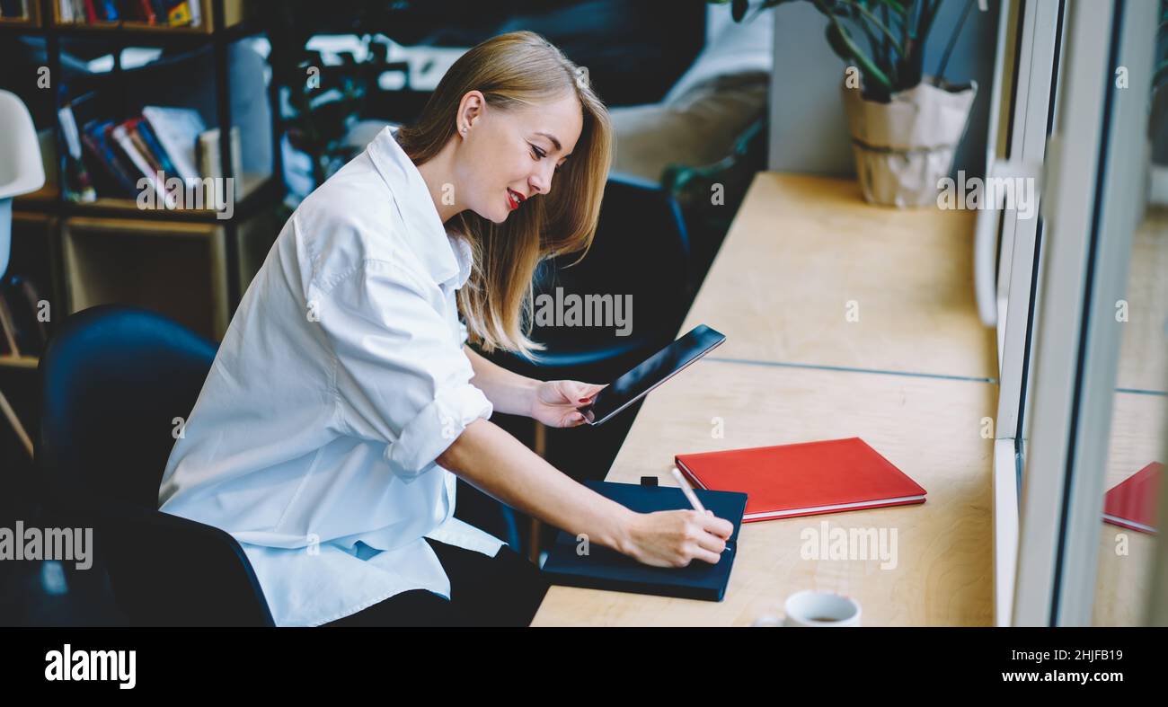 Young woman taking notes from tablet Stock Photo - Alamy