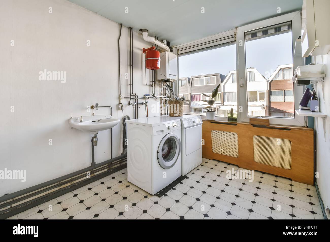 Amazing laundry room with black and white tiled floor Stock Photo - Alamy