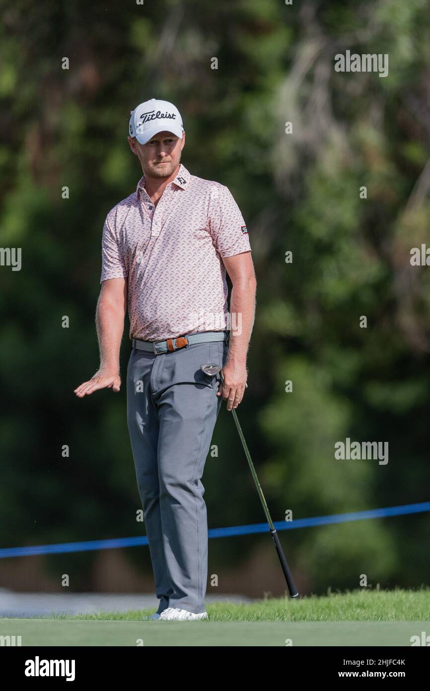 Justin Harding of South Africa watches his shot at the tenth hole ...