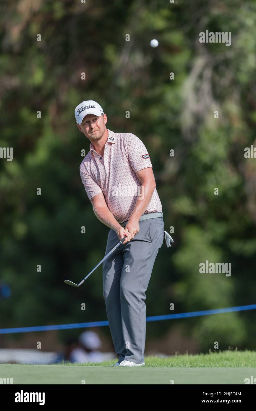 Justin Harding of South Africa chips to the green at the tenth hole ...