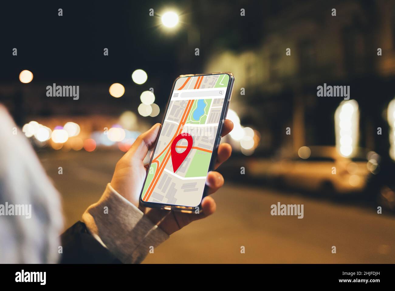 Woman using map application in smartphone to navigate city, concept ...