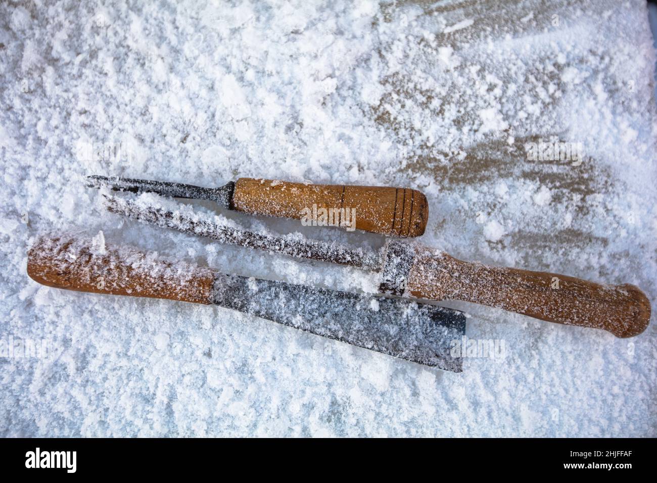 chisels set for ice work on snow background Stock Photo - Alamy