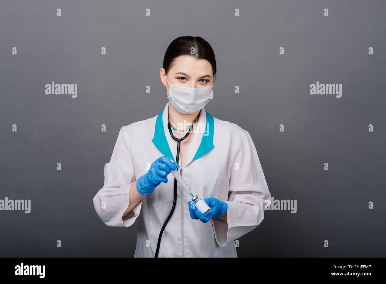Doctor scientist with syringe analyzing virus in a research vaccine to ...
