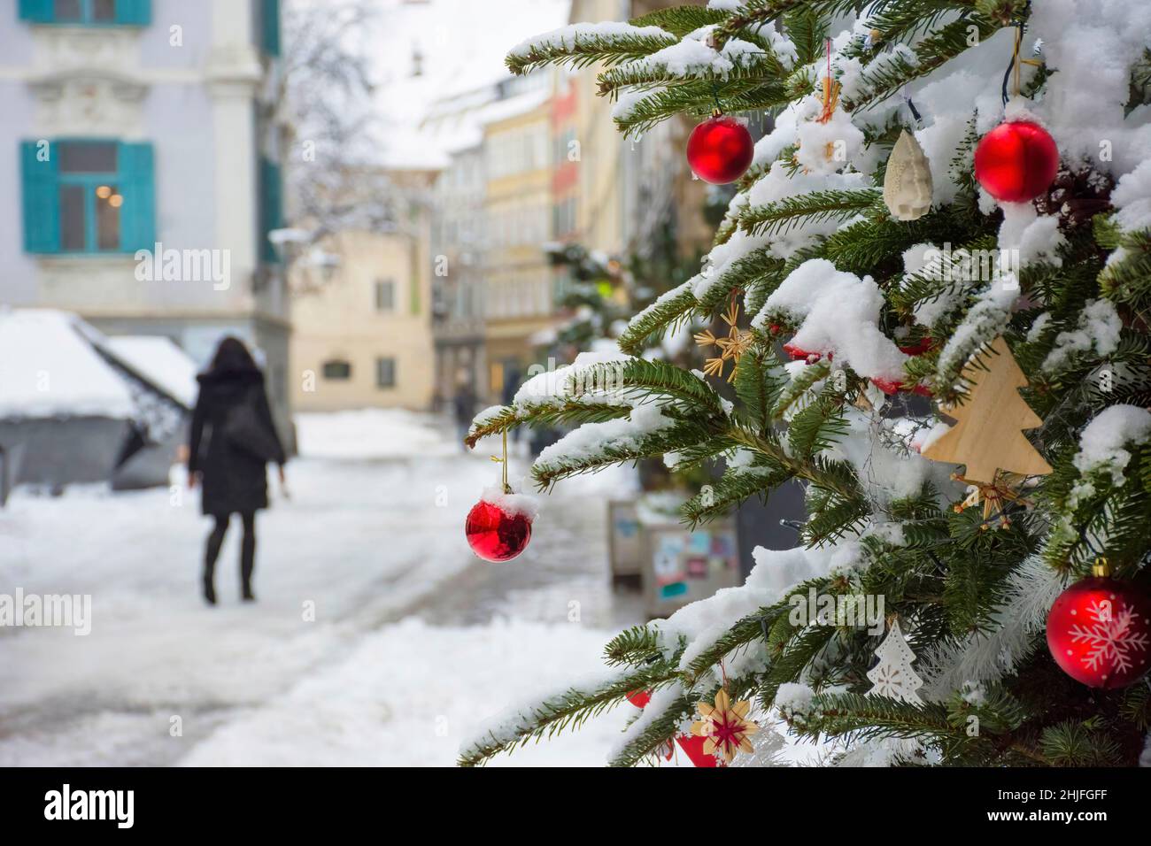 Beautiful Christmas tree detail and blurred people walking through the ...