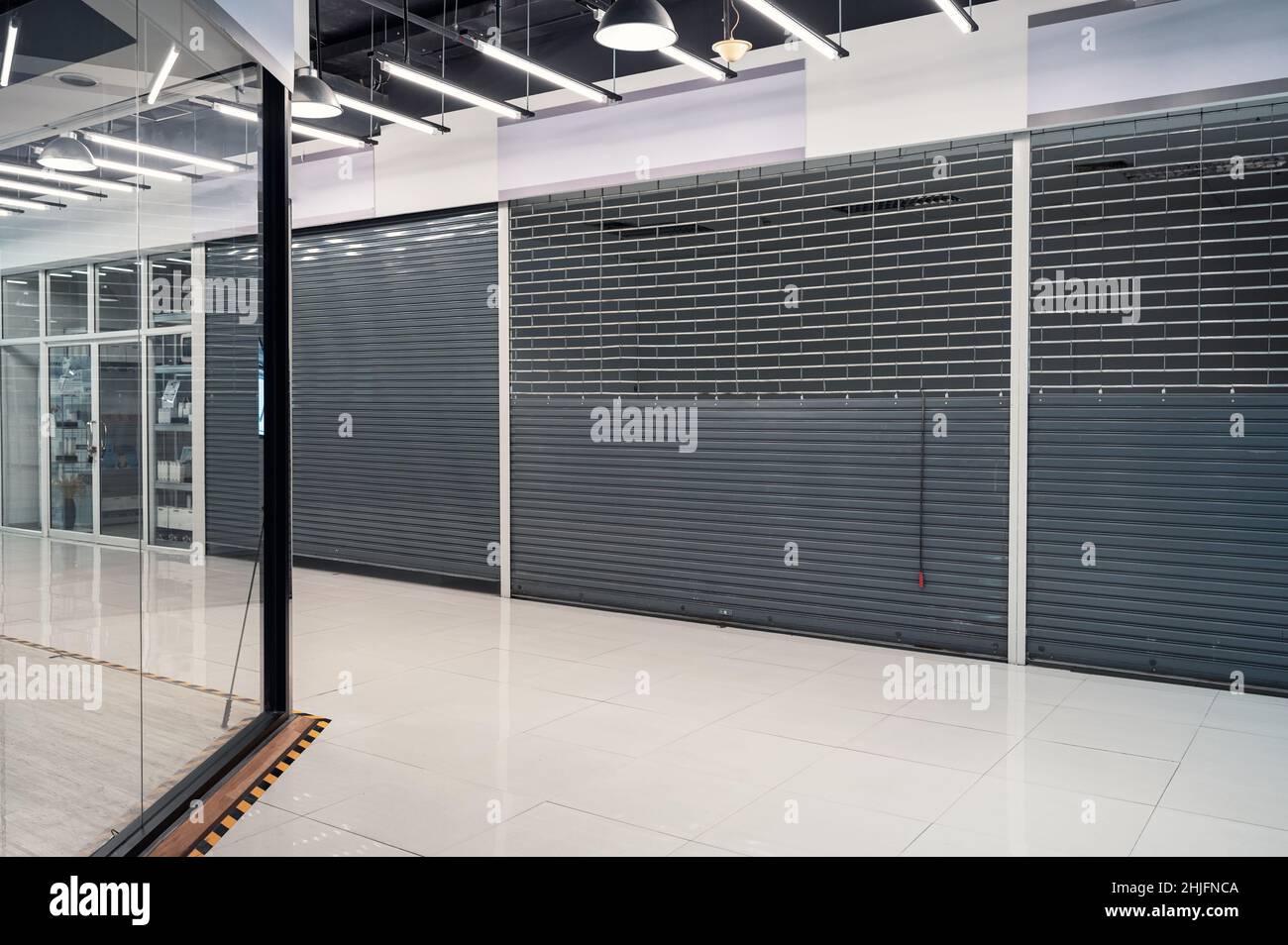 Abandoned closed shutter shop in department store from economic ...