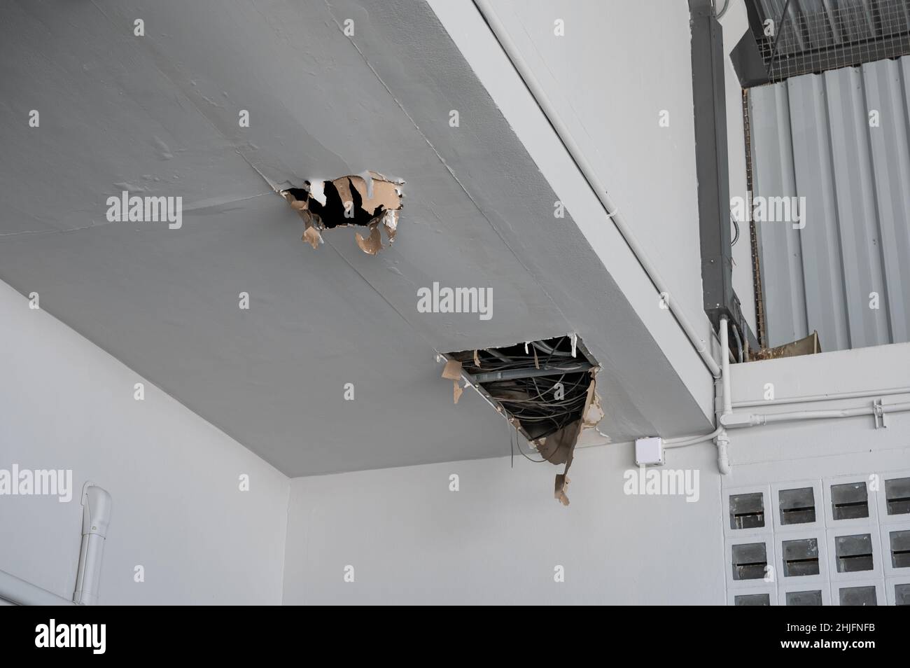 Ceiling panel damaged and crack hole with wire system from rainwater ...