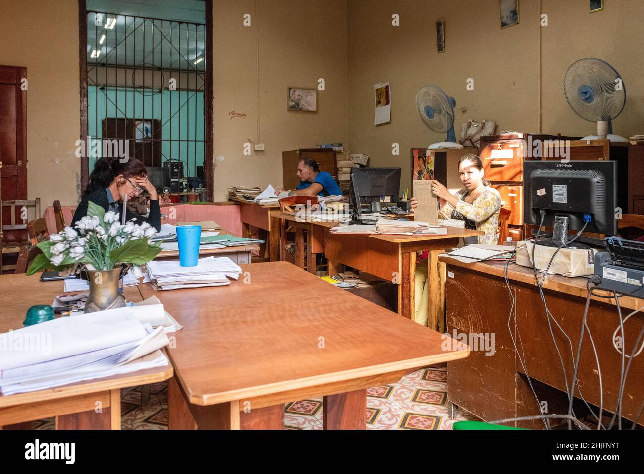 Interior of a Cuban office with people working. Lifestyle and economy ...