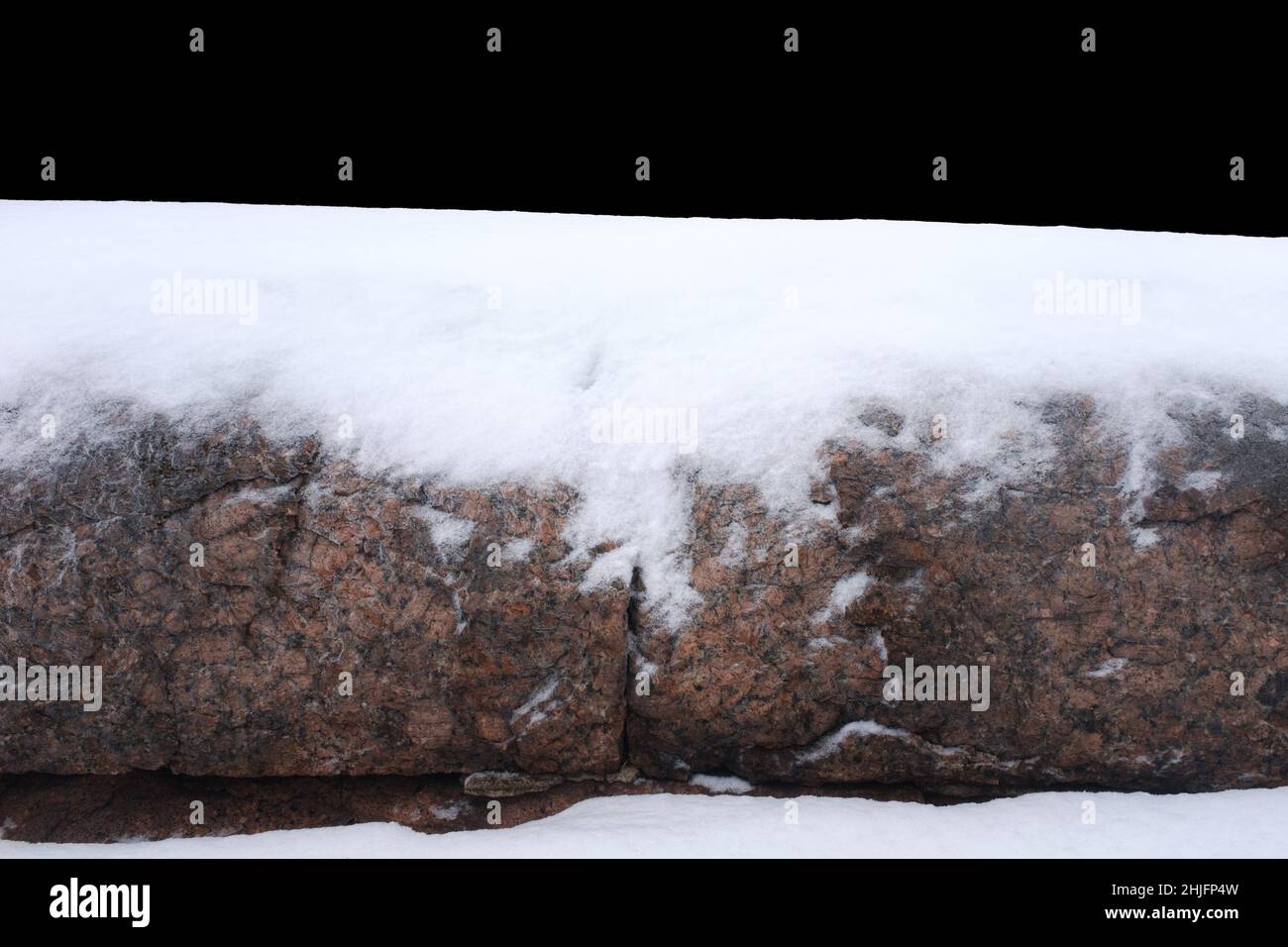 natural stone in snow isolated on black background. High quality photo ...