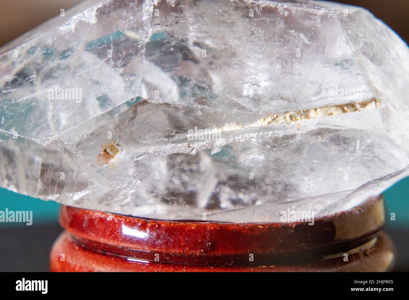 Closeup of a rough clear quartz crystal under the lights with a blurry ...