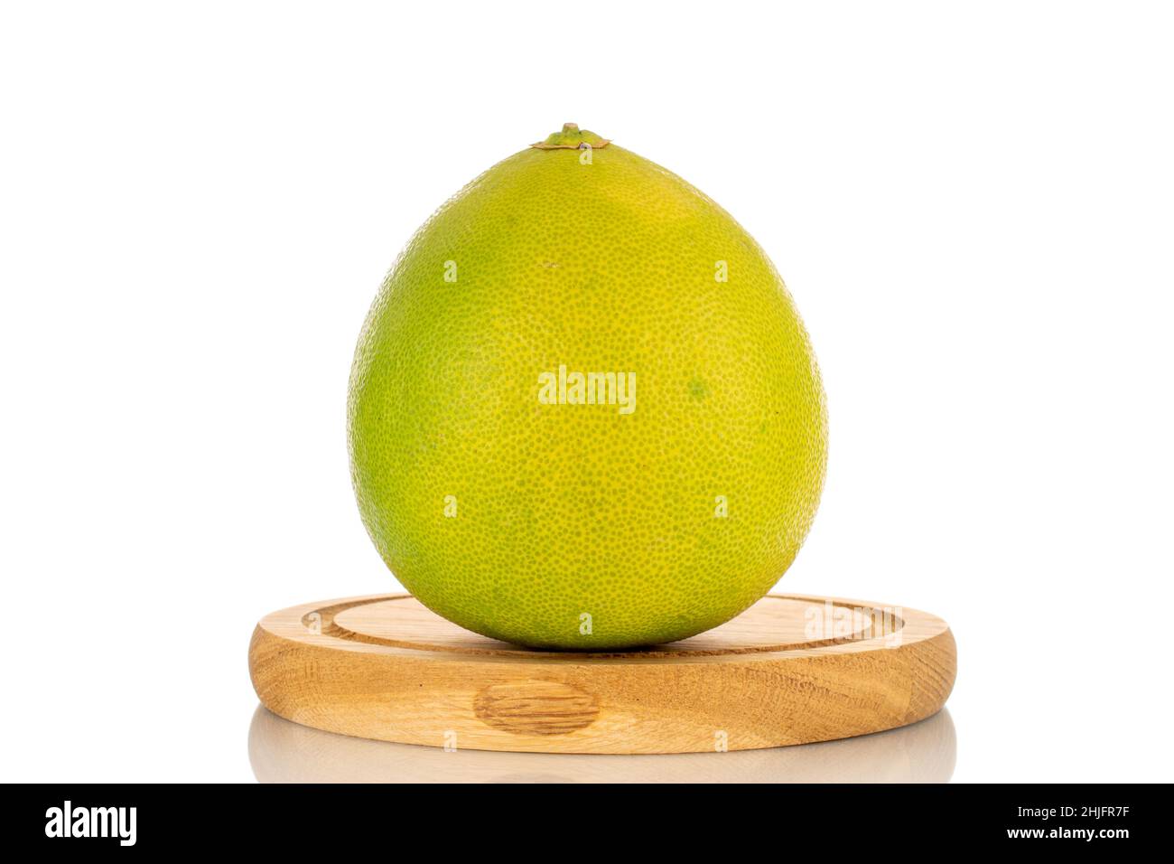 One juicy sweet pomelo on a wooden tray, macro, isolated on white Stock ...