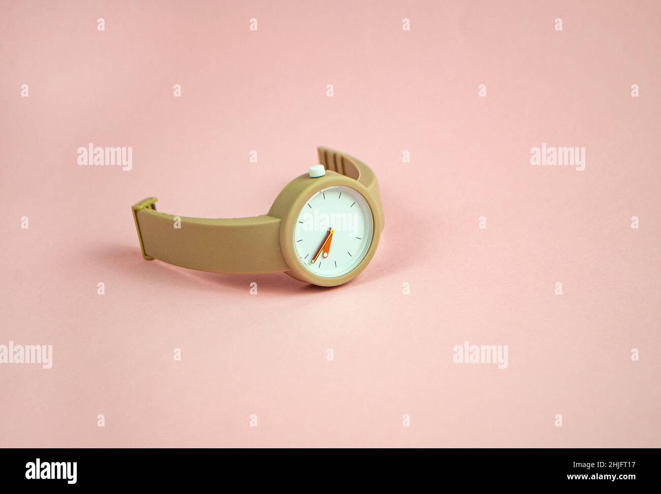 Beige color wristwatch on pastel pink background. Female watch Stock ...