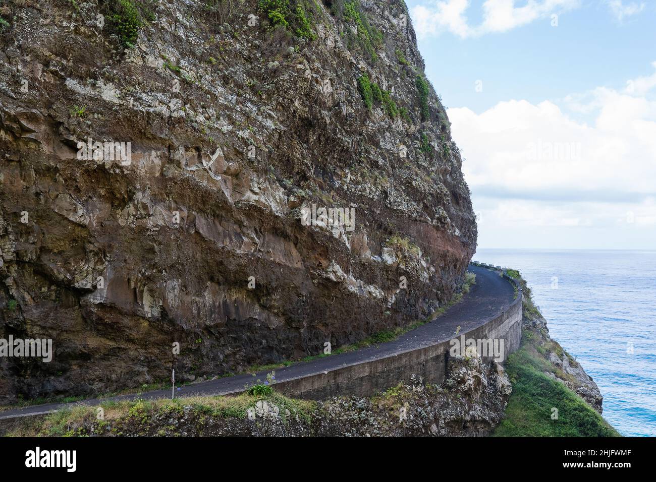 Dangerous part of the old road with rockfall. North coast of the island ...