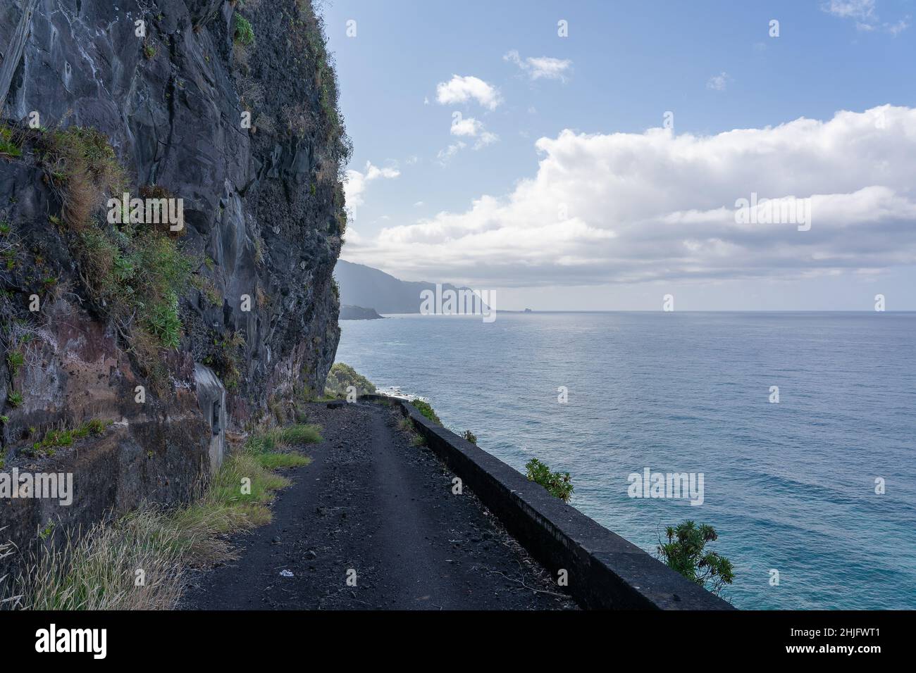 Dangerous part of the old road with rockfall. North coast of the island ...