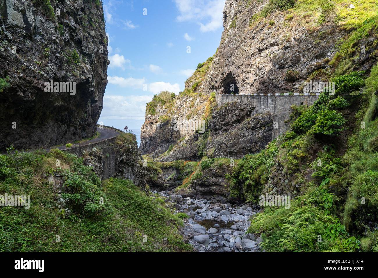 Dangerous part of the old road with rockfall. North coast of the island ...