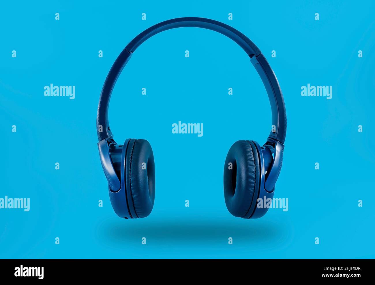 Wireless headphones on a blue background. Wireless connection ...