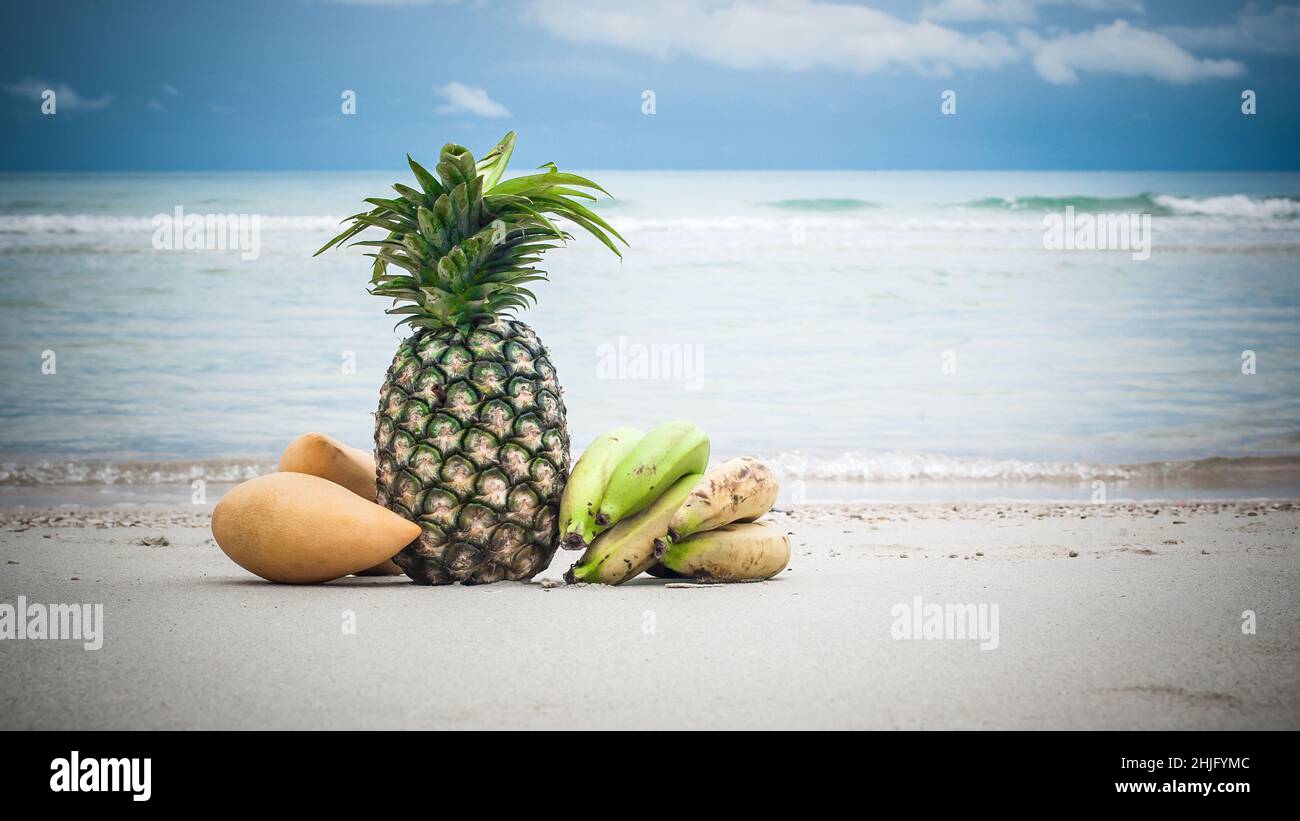 Closeup of exotic and colorful tropical fresh fruit on the beach ...