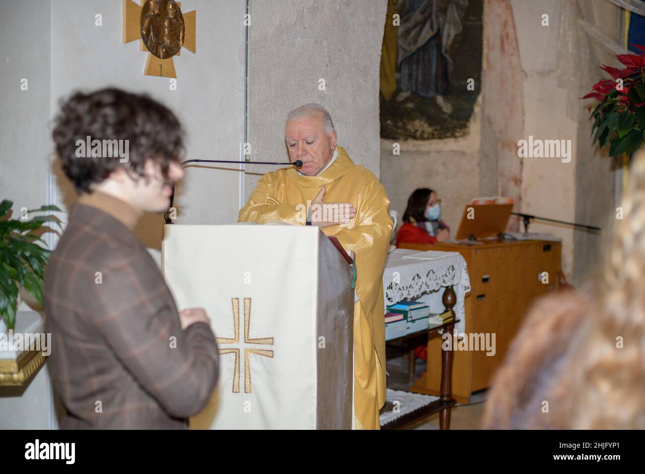 SAN PIETRO, ITALY - DICEMBRE, 26, 2021. The priest pray and give an ...