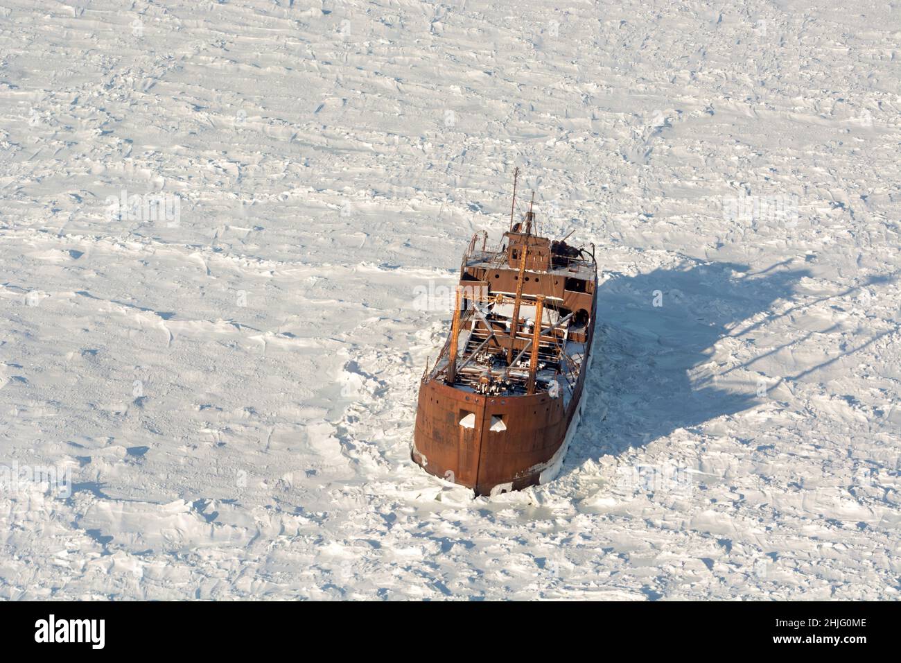 Rusty old shipwreck MV Ithaca surrounded by Ice in Hudson Bay in winter ...