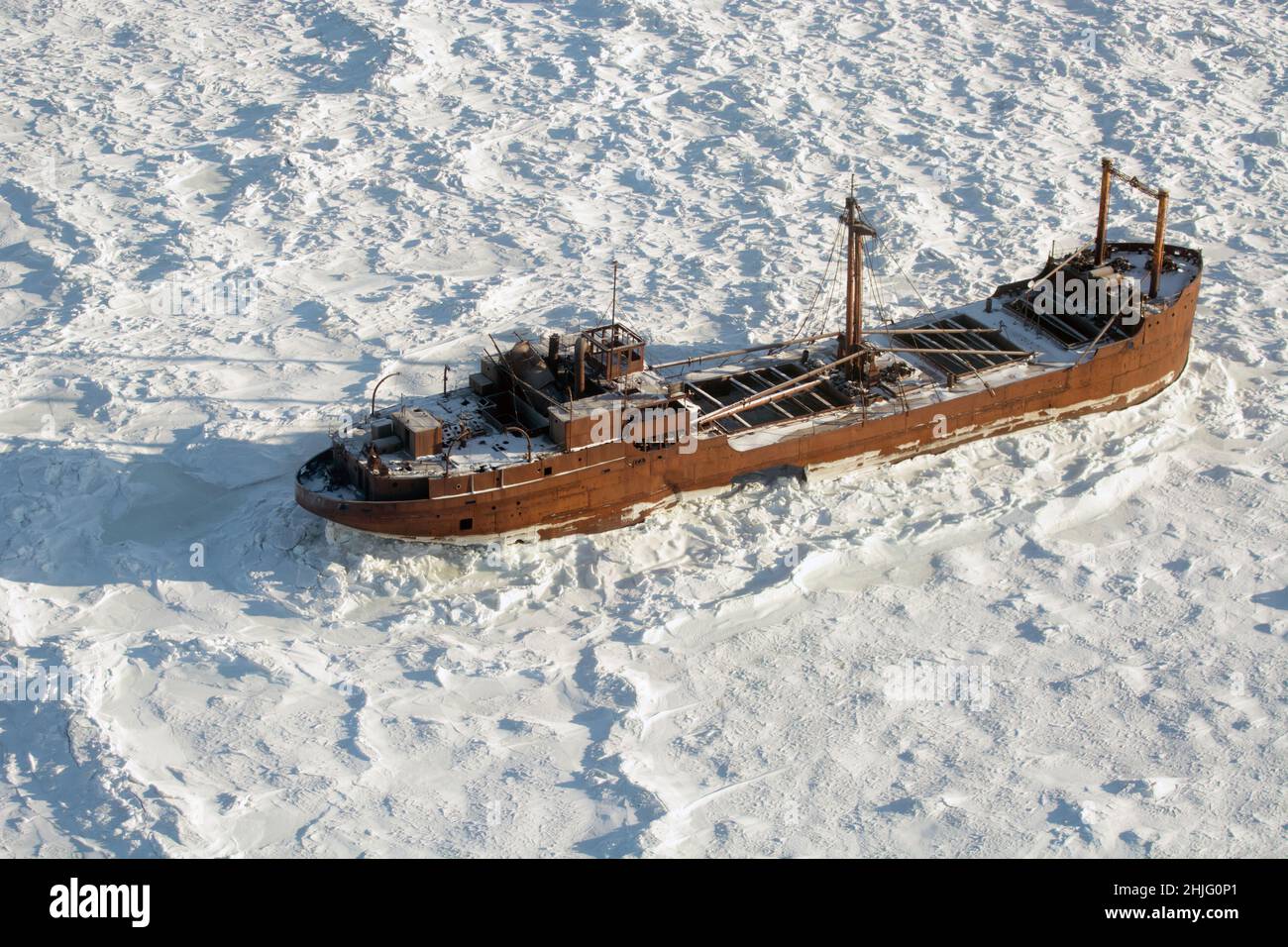 Rusty old shipwreck MV Ithaca surrounded by Ice in Hudson Bay in winter ...