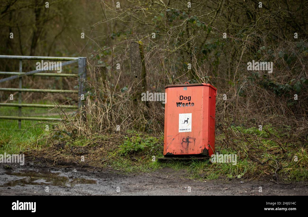 old misused red dog poo bin Stock Photo - Alamy
