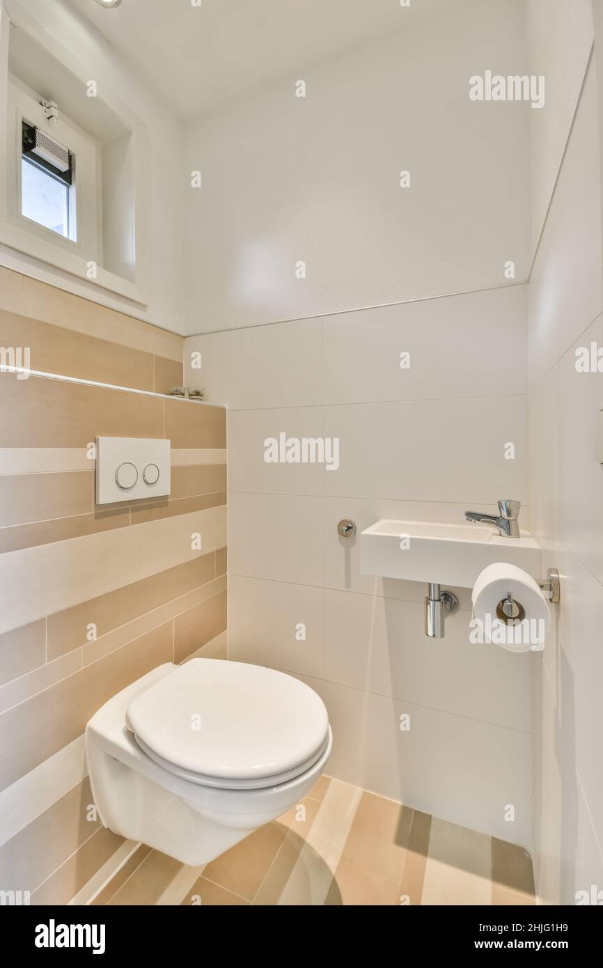Interior of small clean restroom in miniature style Stock Photo - Alamy
