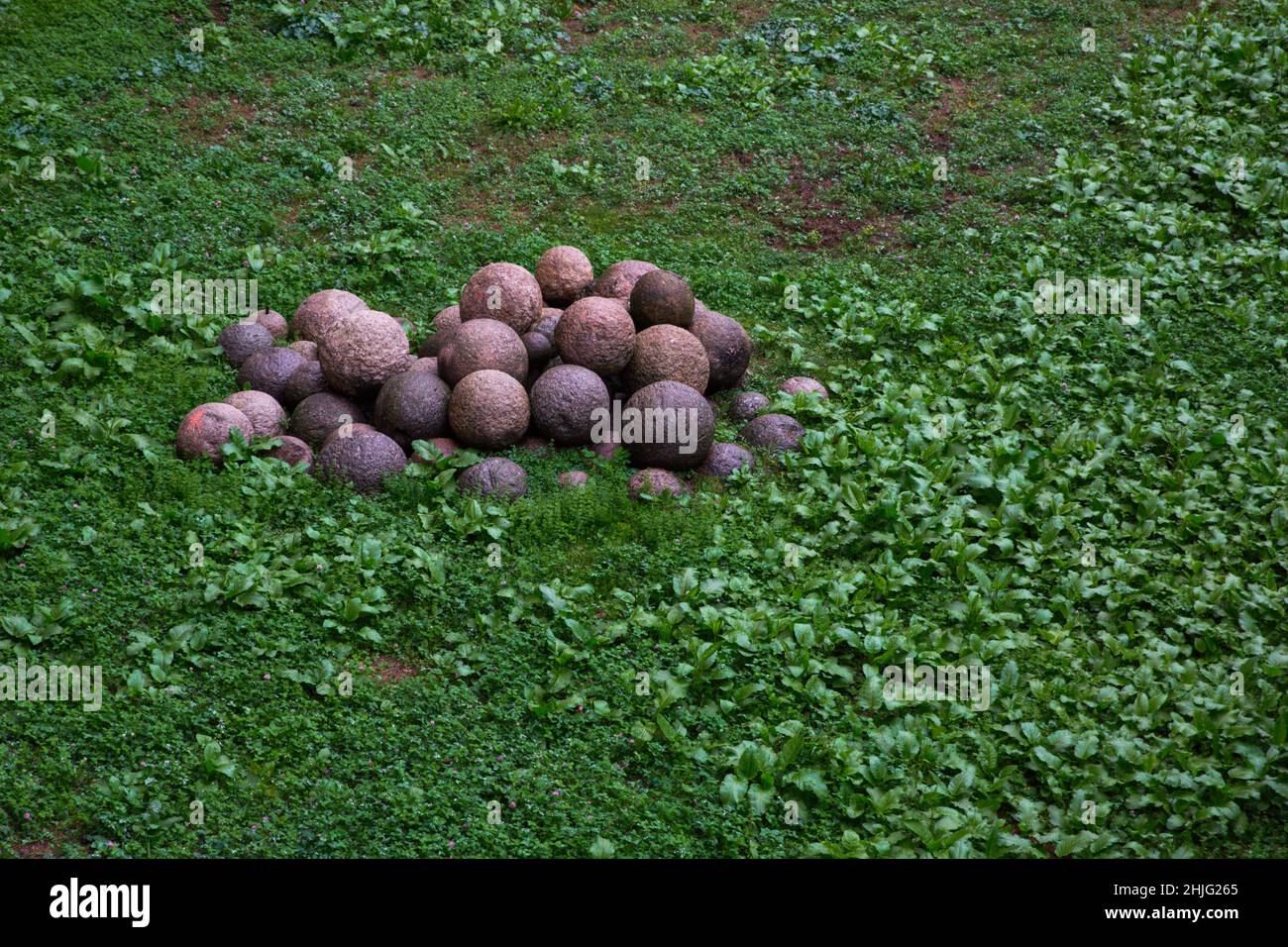 Group o the round stone balls on the green grass Stock Photo - Alamy