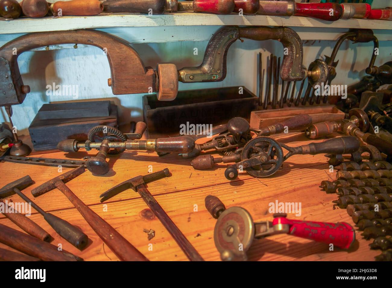 A collection of old woodworking tools laying on a workbench assortment ...
