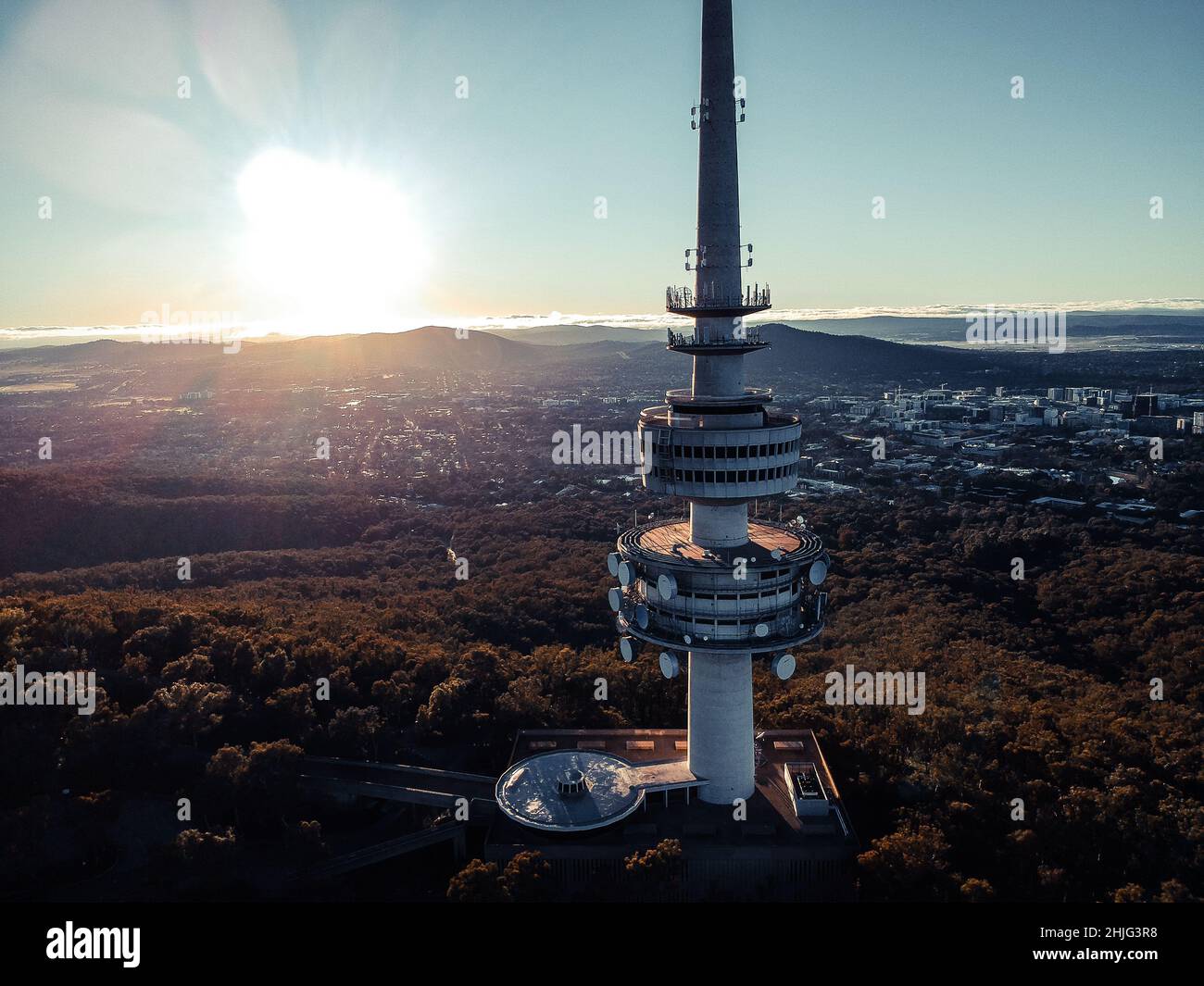 Telstra Tower surrounded by trees under the sunlight in Canberra ...