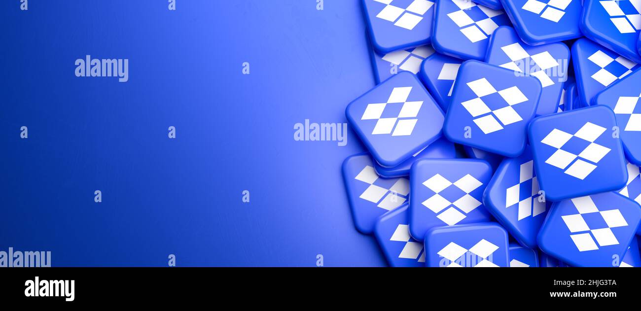 Logos of the Cloud Drive service Dropbox on a heap on a table. Copy ...