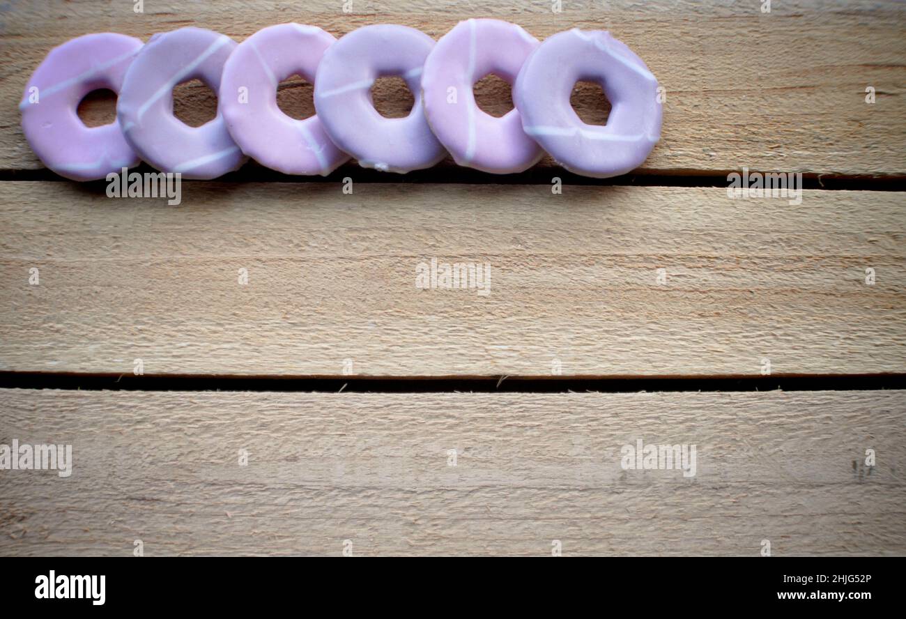 Party ring biscuits by FOX's set against a wooden background with copy ...