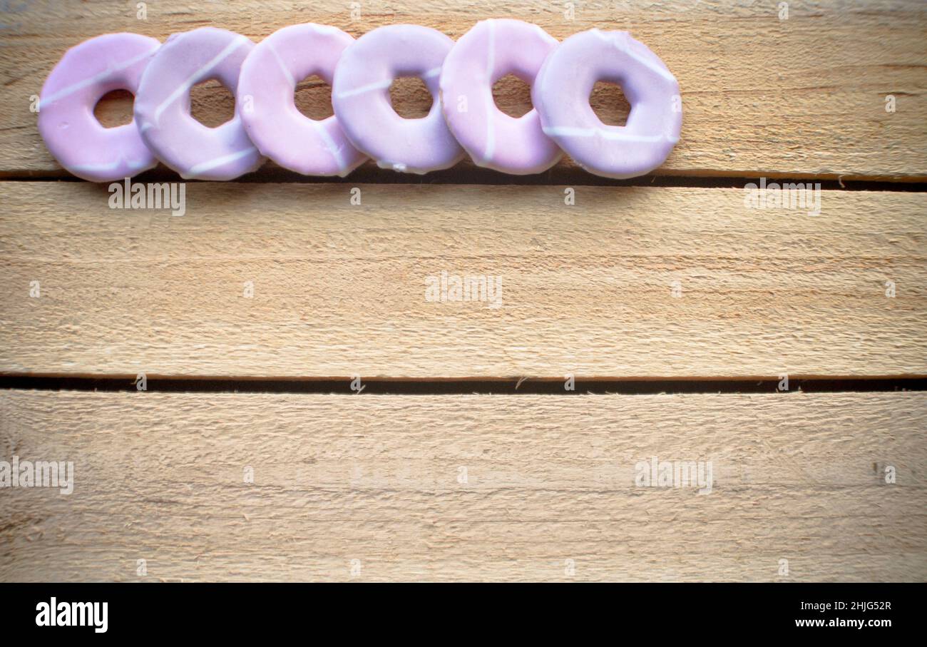 Party ring biscuits by FOX's set against a wooden background with copy ...