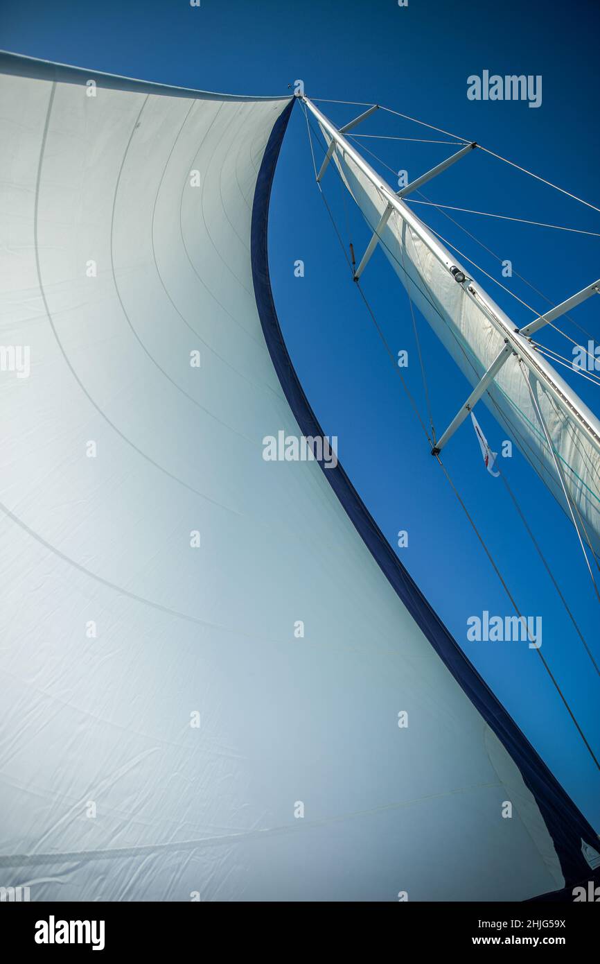 Sails filled with wind against the sky. Wind greatly inflated yacht ...