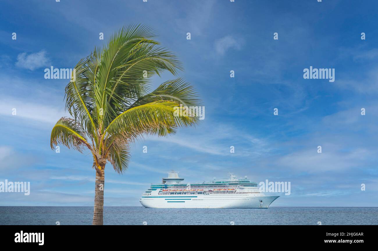 Cruise ship in Caribbean sea with palm tree on foreground. Landscape ...