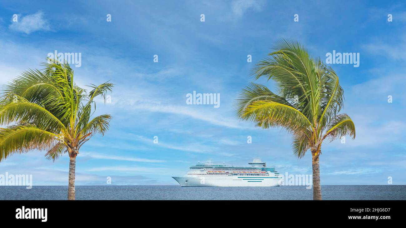 Cruise ship in Caribbean sea with palm tree on foreground. Landscape ...