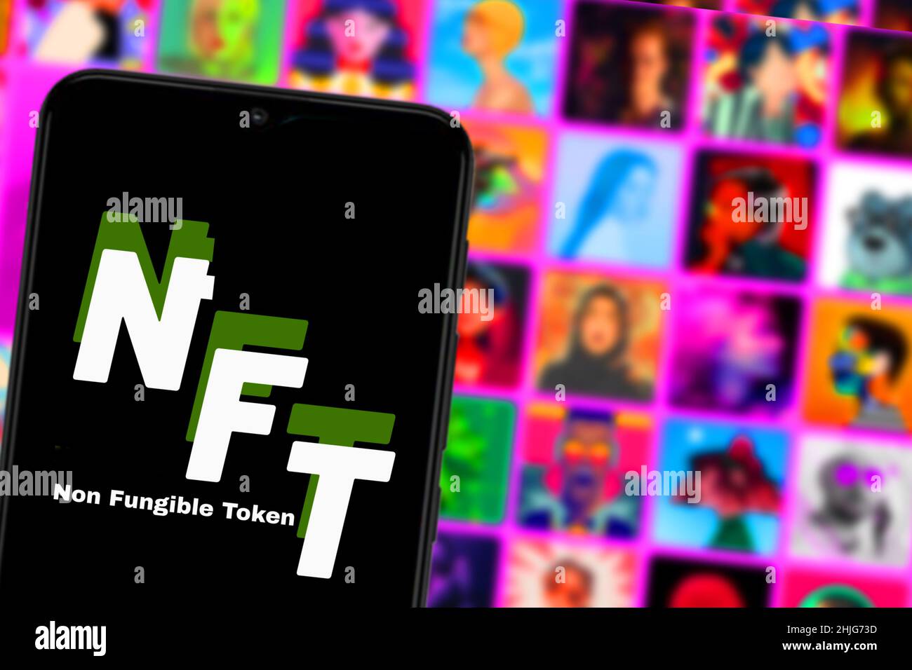 Smartphone with the acronym “NFT” logo refers to a non-fungible token ...