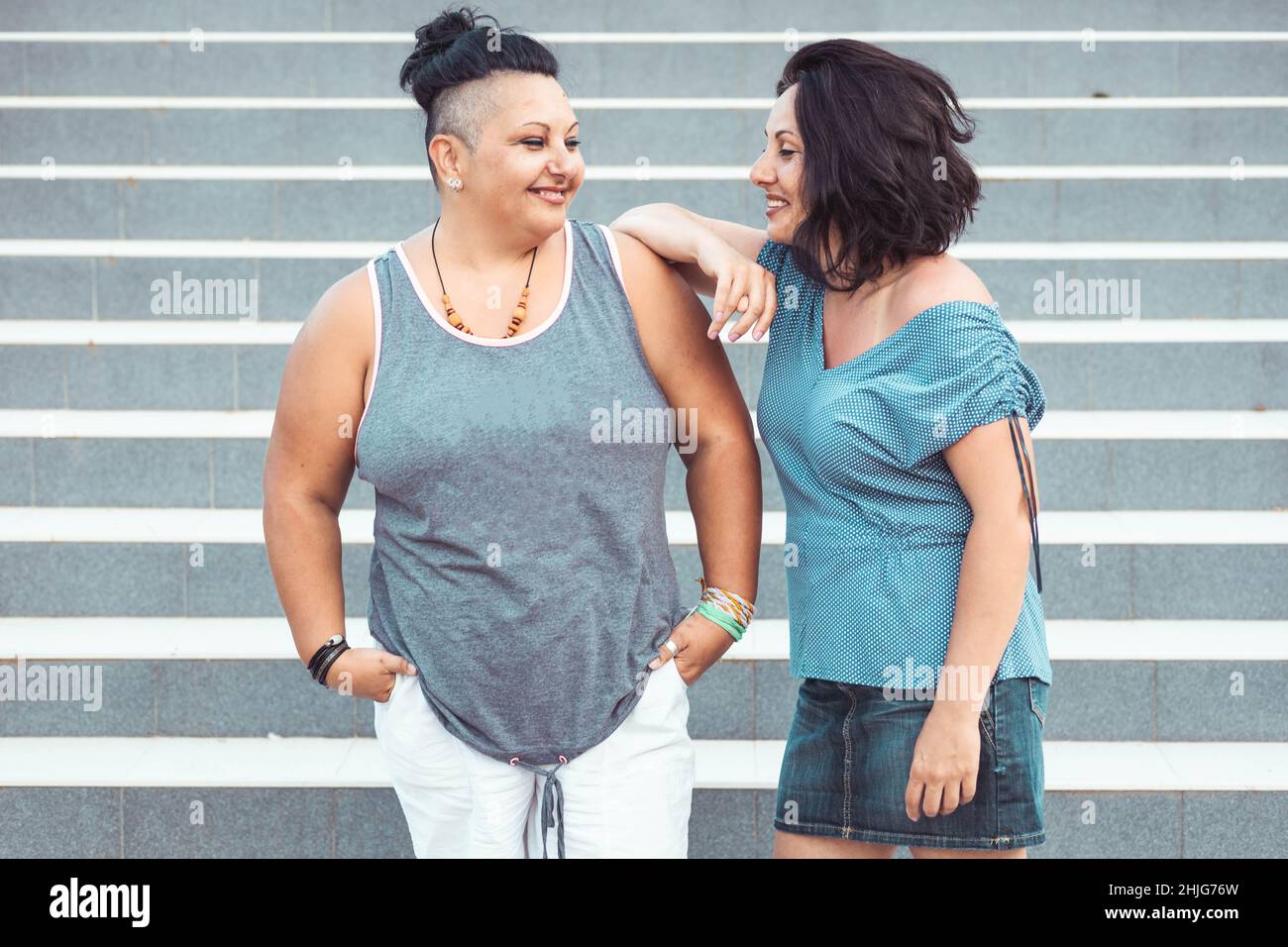 Portrait of two adult brunette twin sisters. Different styles Stock ...