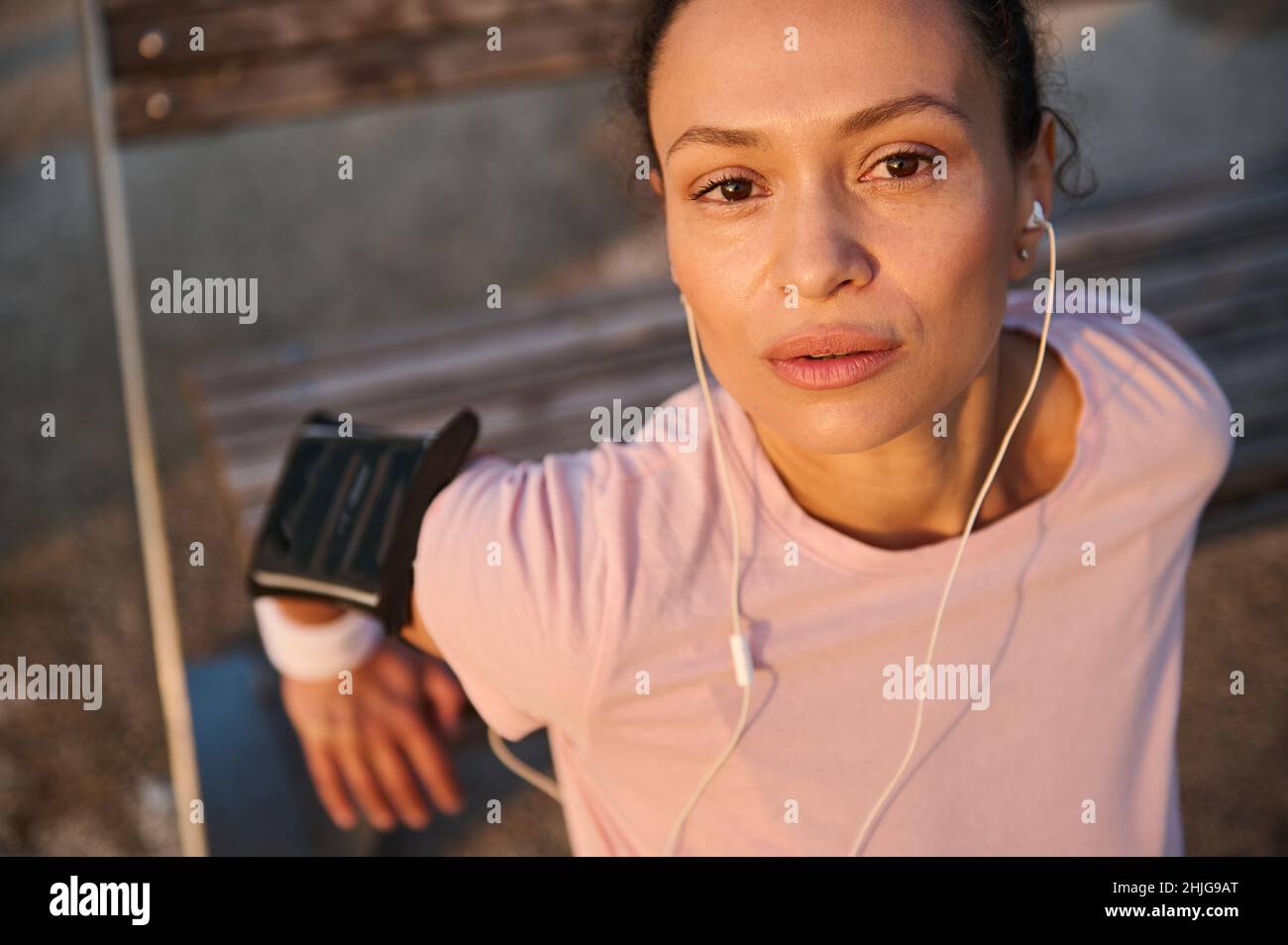 Close-up. Headshot of sportswoman, female athlete in pink t-shirt, with ...