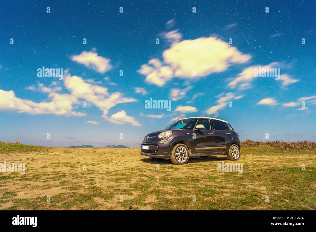 off roader car with lights on stopped in the desert at night under the ...