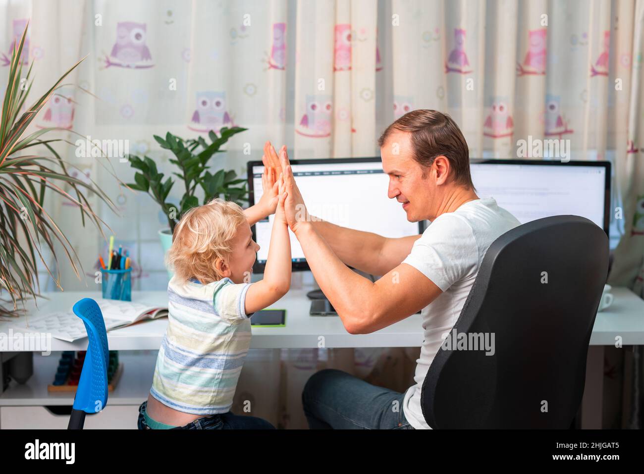 Father with kid trying to work from home during quarantine. Stay at ...