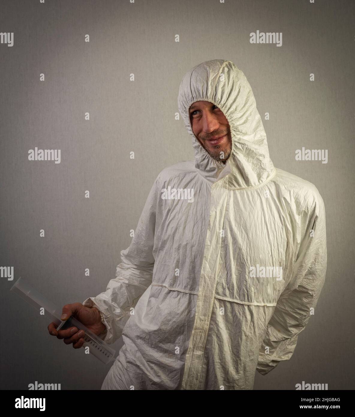 Man with white protection suit and big shot injection with white gray ...