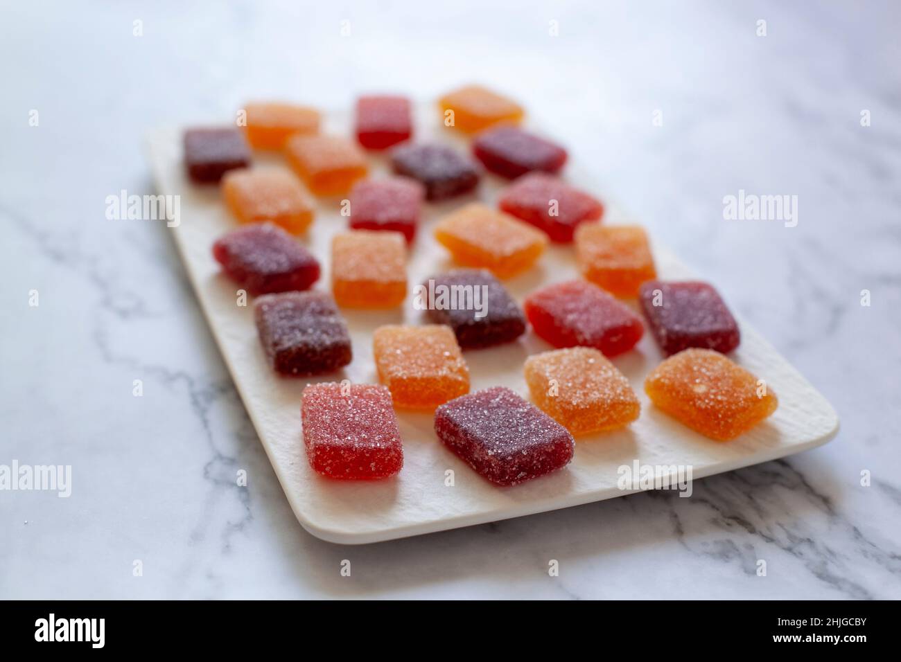 different tastes fruit paste on a square plate on marble background ...