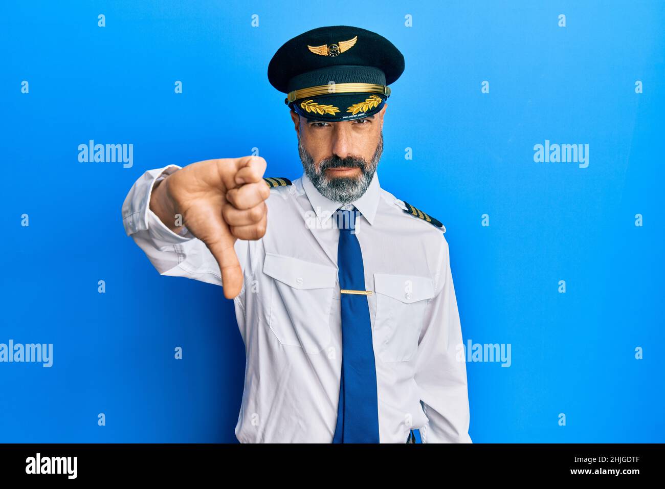 Middle age man with beard and grey hair wearing airplane pilot uniform ...