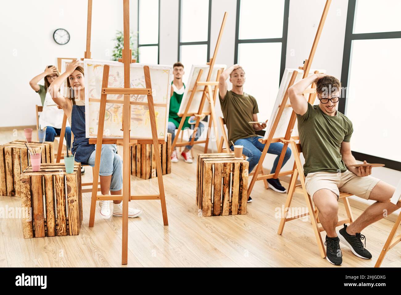 Group of young people drawing at art studio stressed and frustrated ...