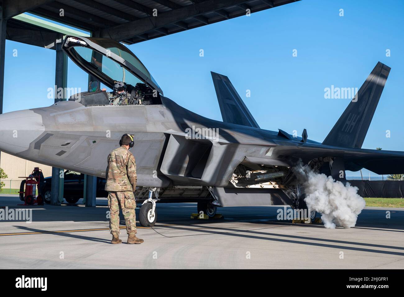 A Total Force F-22 Raptor pilot conducts a preflight check on the ...